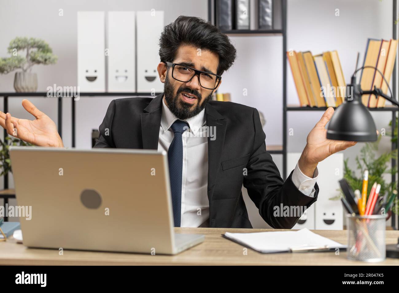 I dont know what to say. Confused business man working on laptop at ...