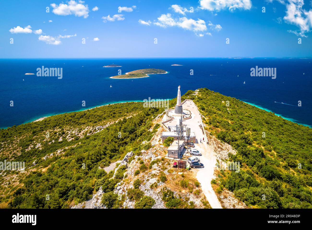 Giant Virgin Mary statue on hill above Primosten aerial view, Dalmatia ...