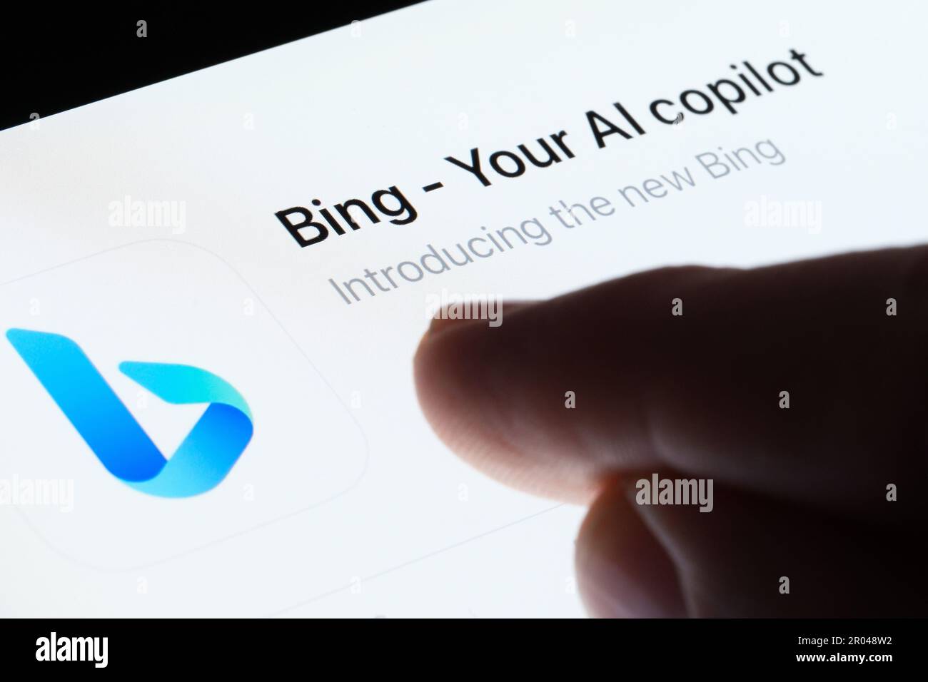 Bing app seen in App Store on the screen of ipad and blurred finger ...