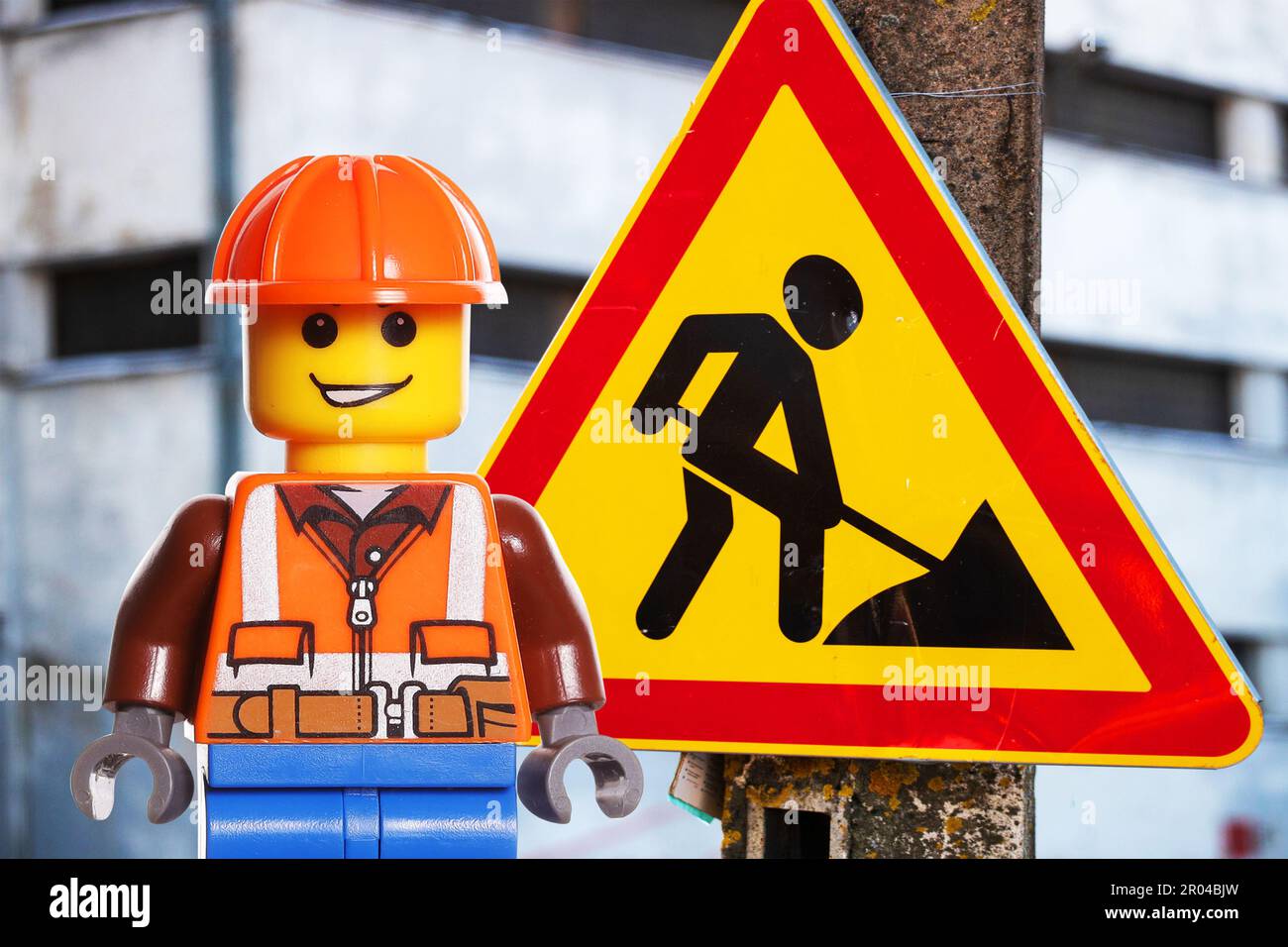 Russia Vyborg 04.04.2023 Lego figure of a builder on the background of ...