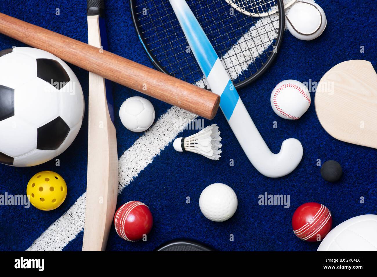 Sports equipment, rackets, bat and balls on blue sport background ...