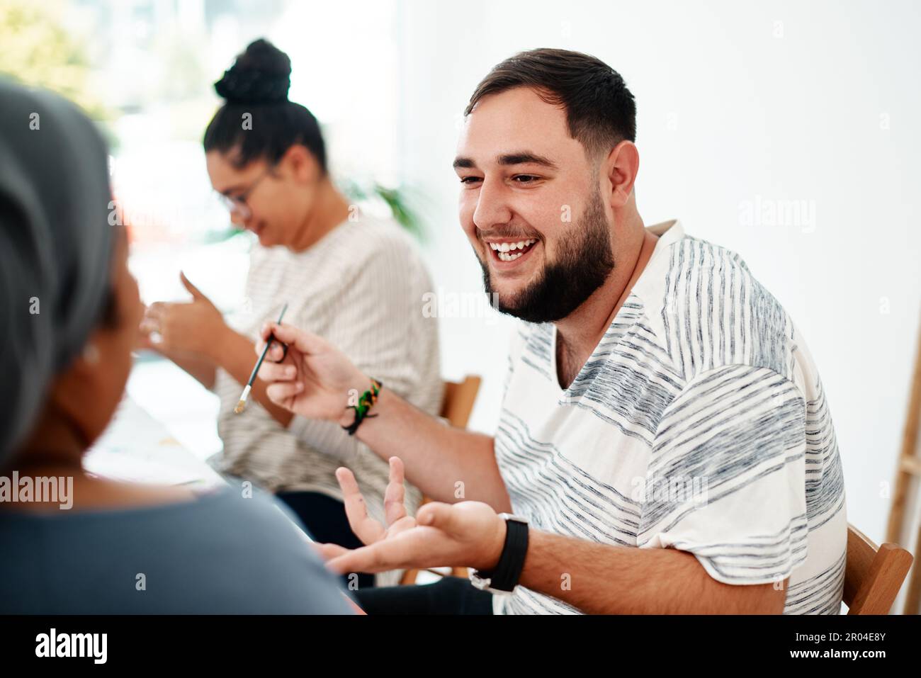 Friends are the sunshine of life. a diverse group of artists sitting ...
