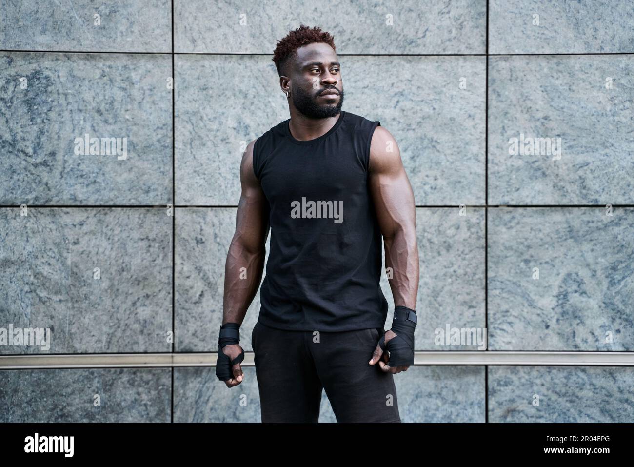 Strong confident sporty young black man boxer fighter standing outdoors ...
