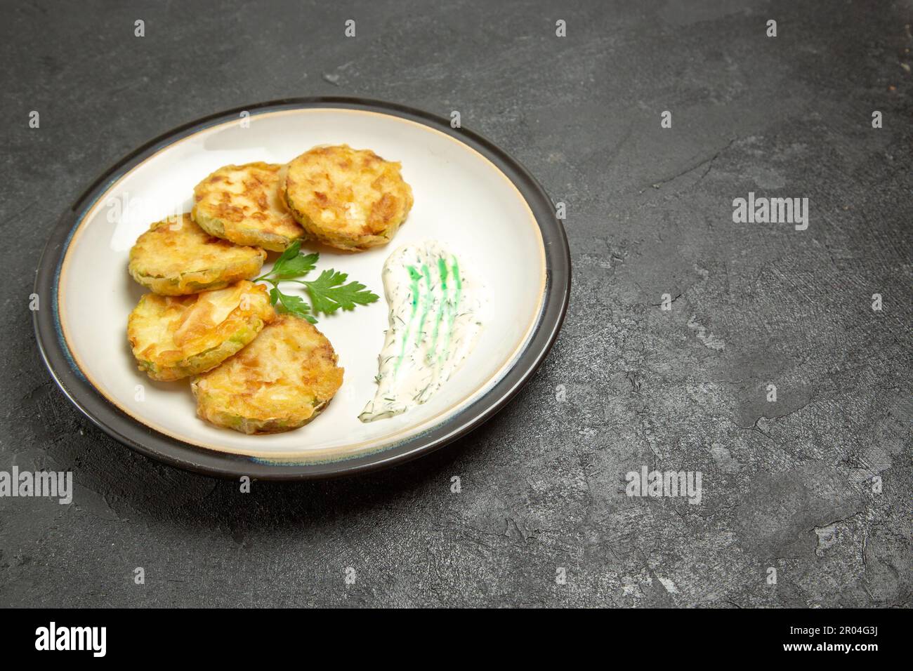 front view delicious cooked squashes slices inside plate on a dark grey ...