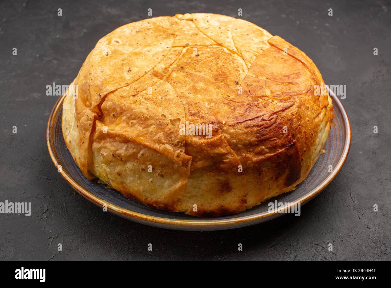 front view tasty shakh plov cooked rice inside round dough on grey ...