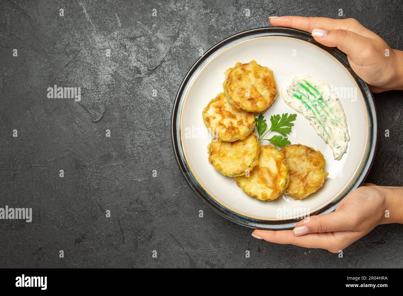 top view cooked squashes slices inside plate on a dark grey background ...