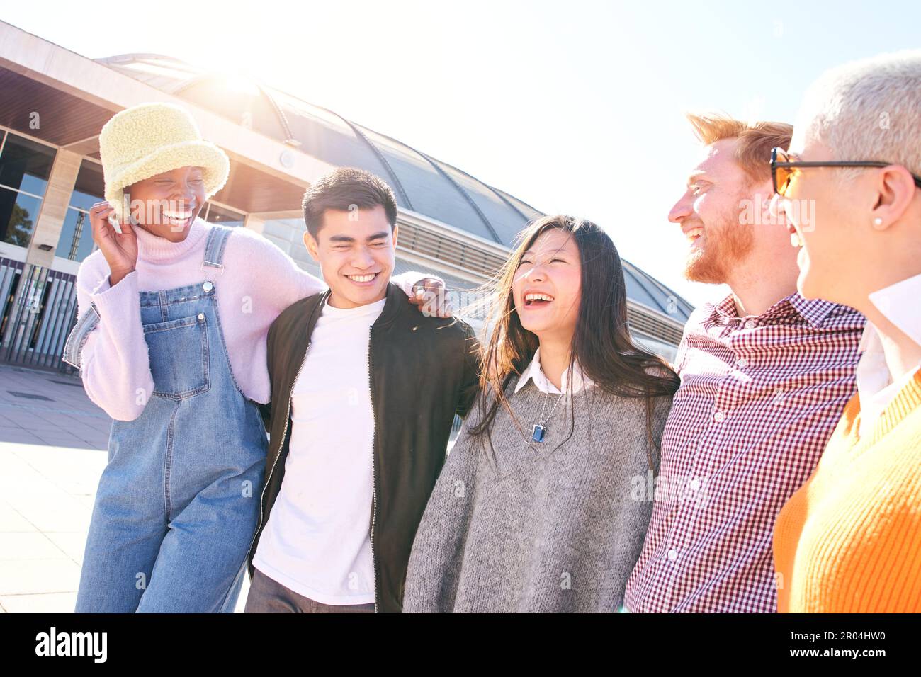 Cheerful group of multicultural friends hugging and smiling. Concept of ...