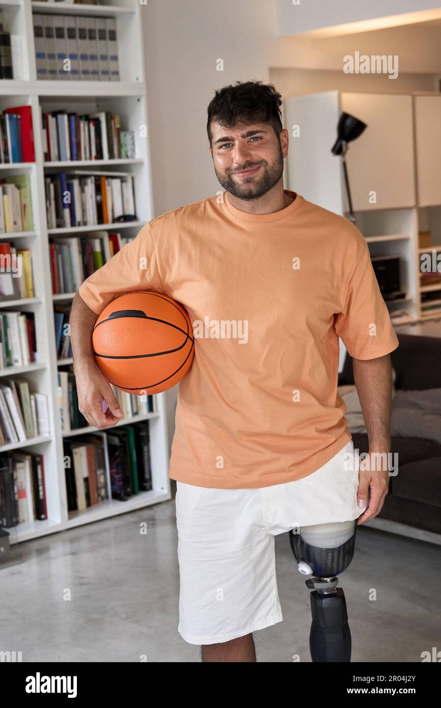 Amputee man with prosthetic leg prosthesis posing with basketball ball ...