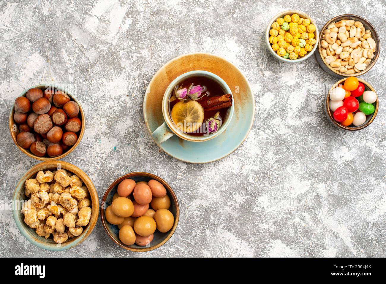 top view cup of tea with nuts and candies on white background snack tea ...