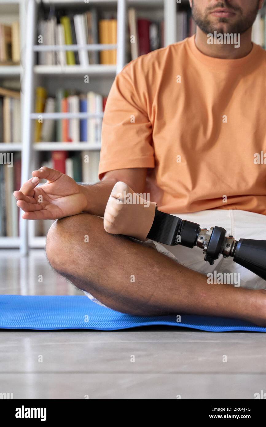 Amputee man with prosthetic leg prosthesis meditating doing yoga at ...
