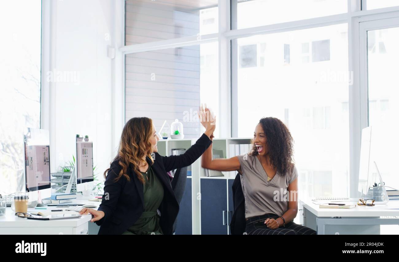 When you work together, you win together. two young businesswomen ...