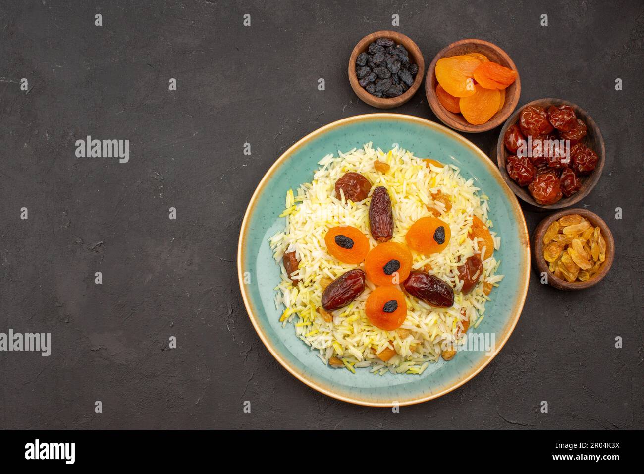 top view delicious cooked plov rice with different raisins inside plate ...