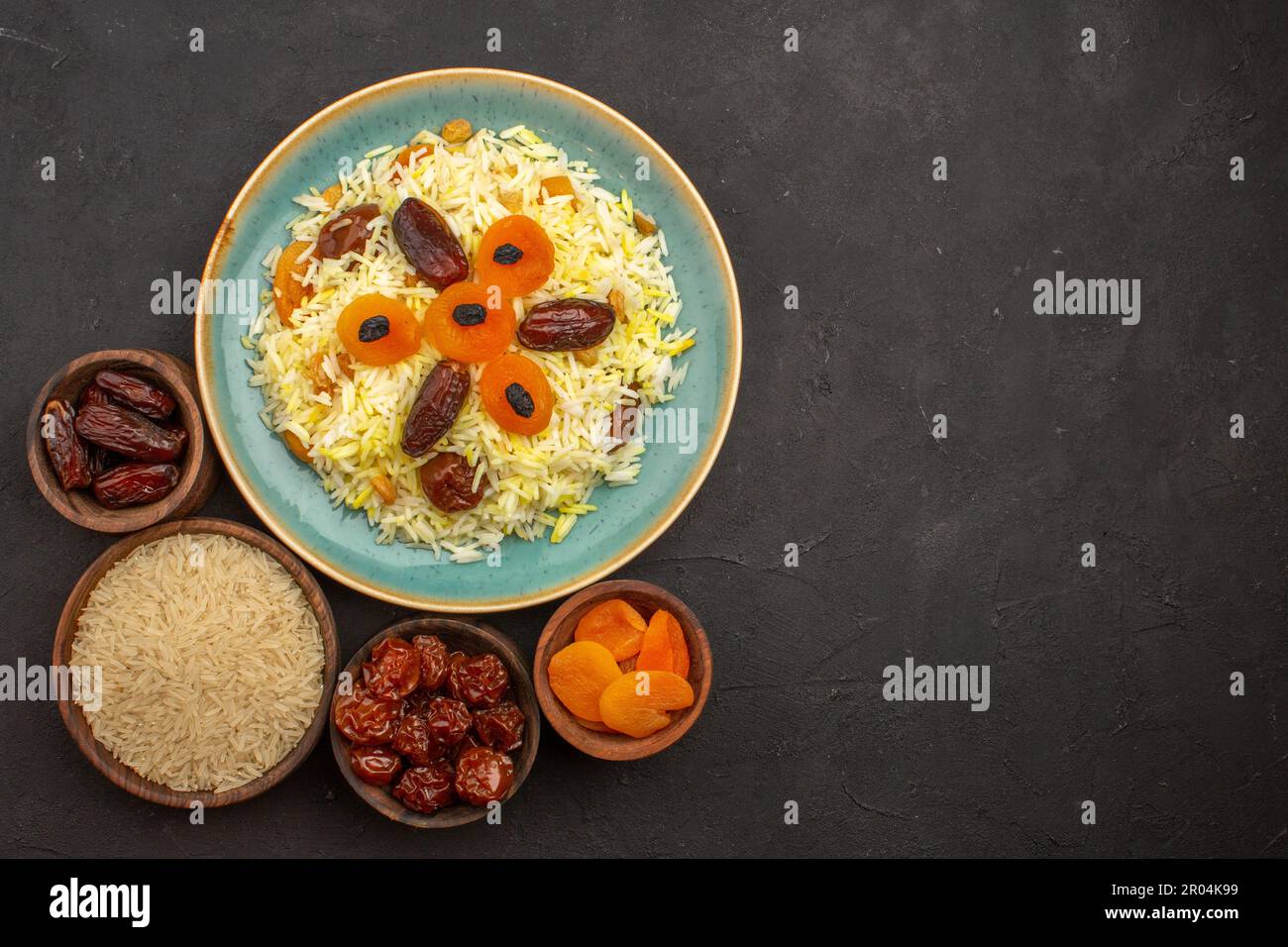 top view delicious cooked plov rice with different raisins inside plate ...