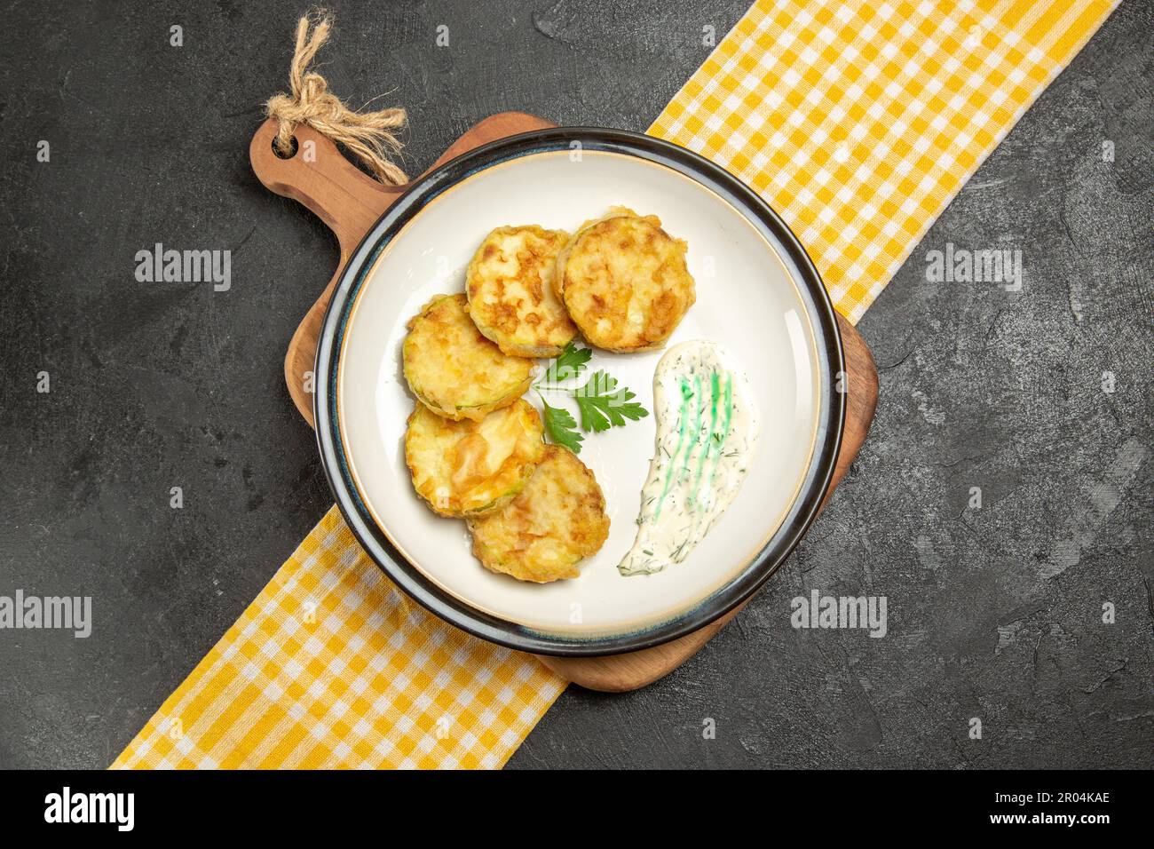 top view delicious cooked squashes slices inside plate on a dark grey ...