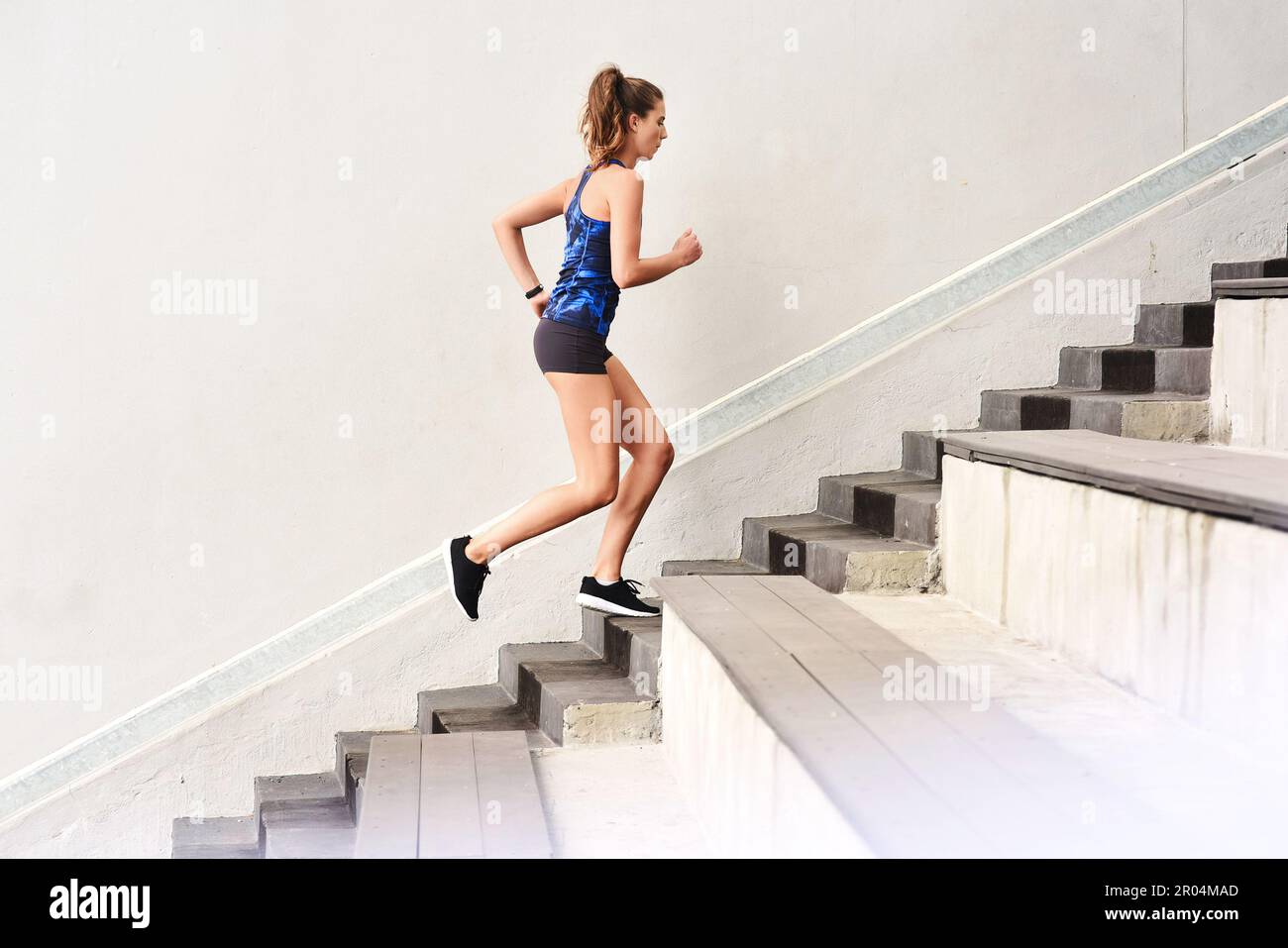 Shes on the way up. Full length shot of an attractive young female athlete working out on a ...