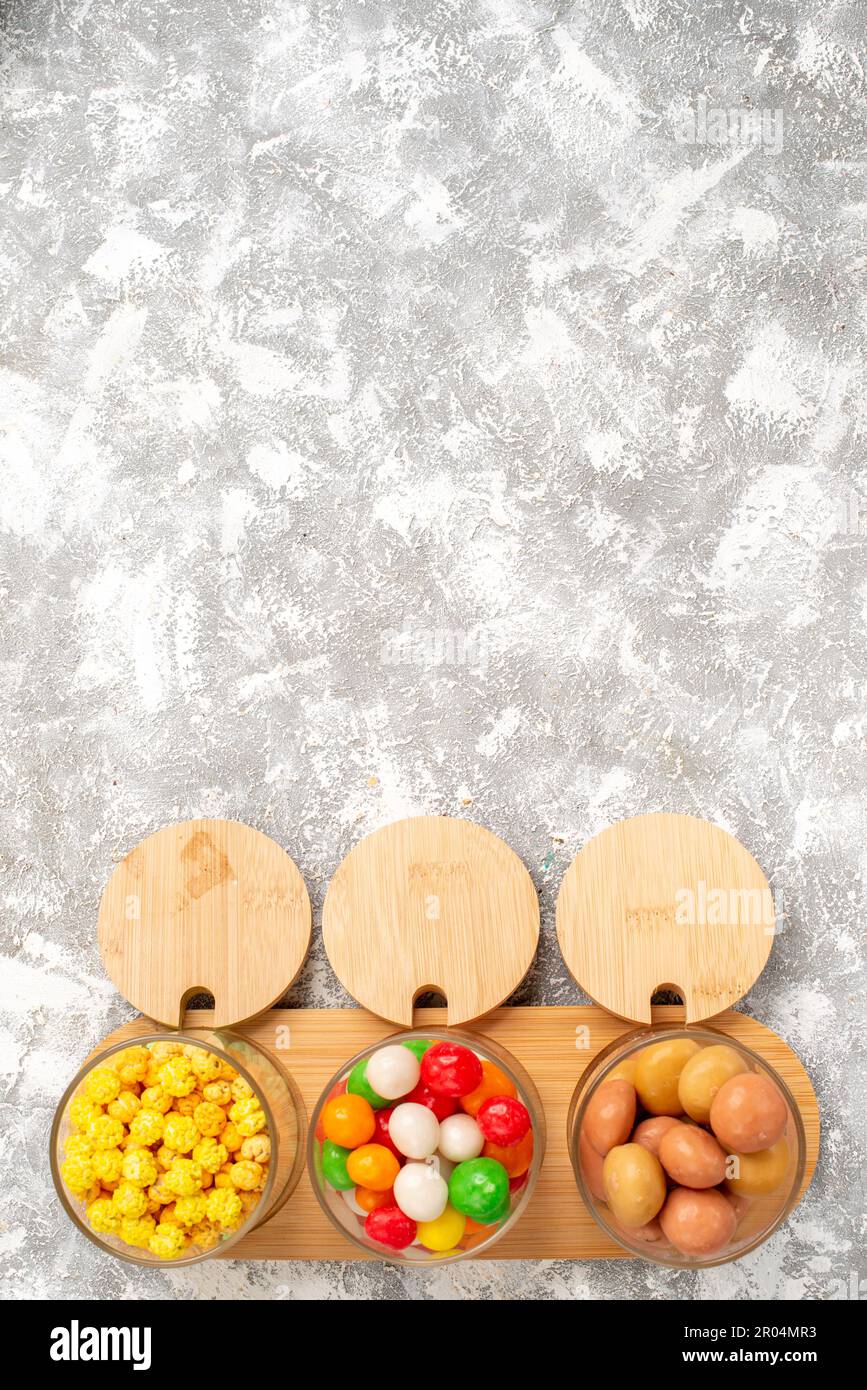 top view different candies colorful sweets on the white background ...