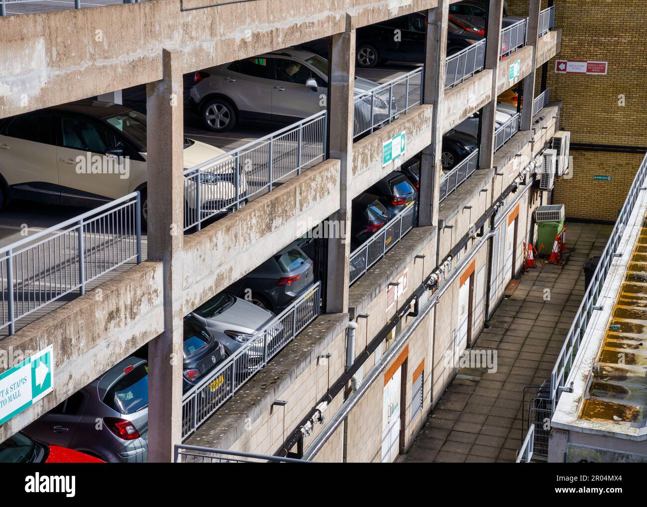 A colorful array of cars parked in multi-level tiers in a modern ...