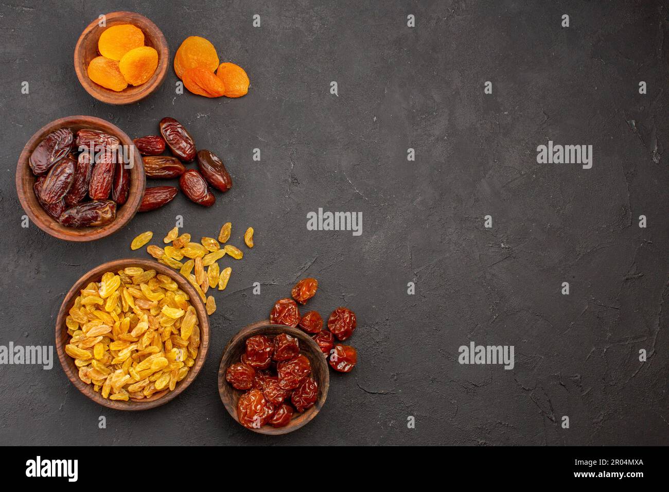 top view different raisins from grape with dried apricots on a grey ...