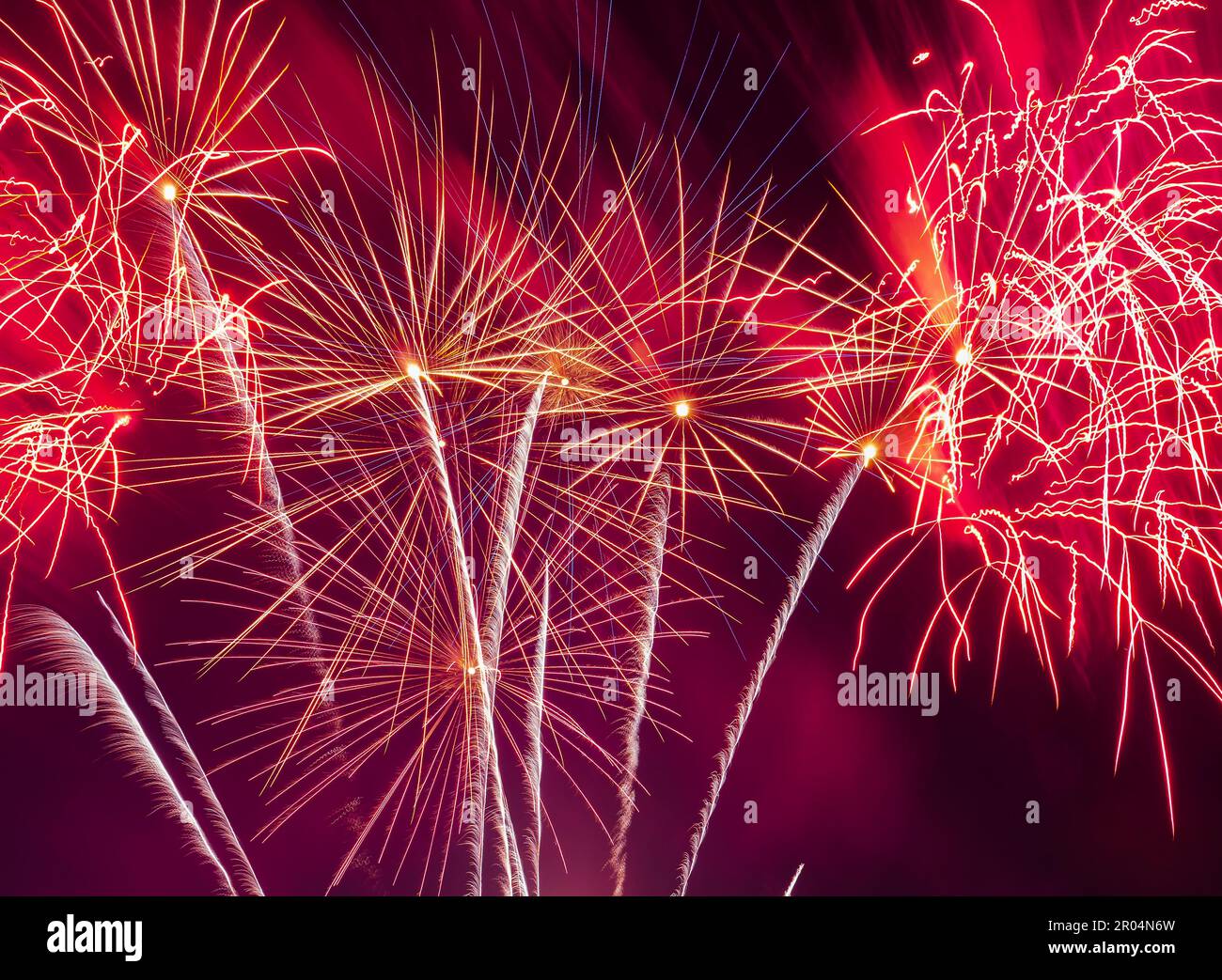 Festive New Year's fireworks. Bright beams of bursting fireworks against dark background of ...