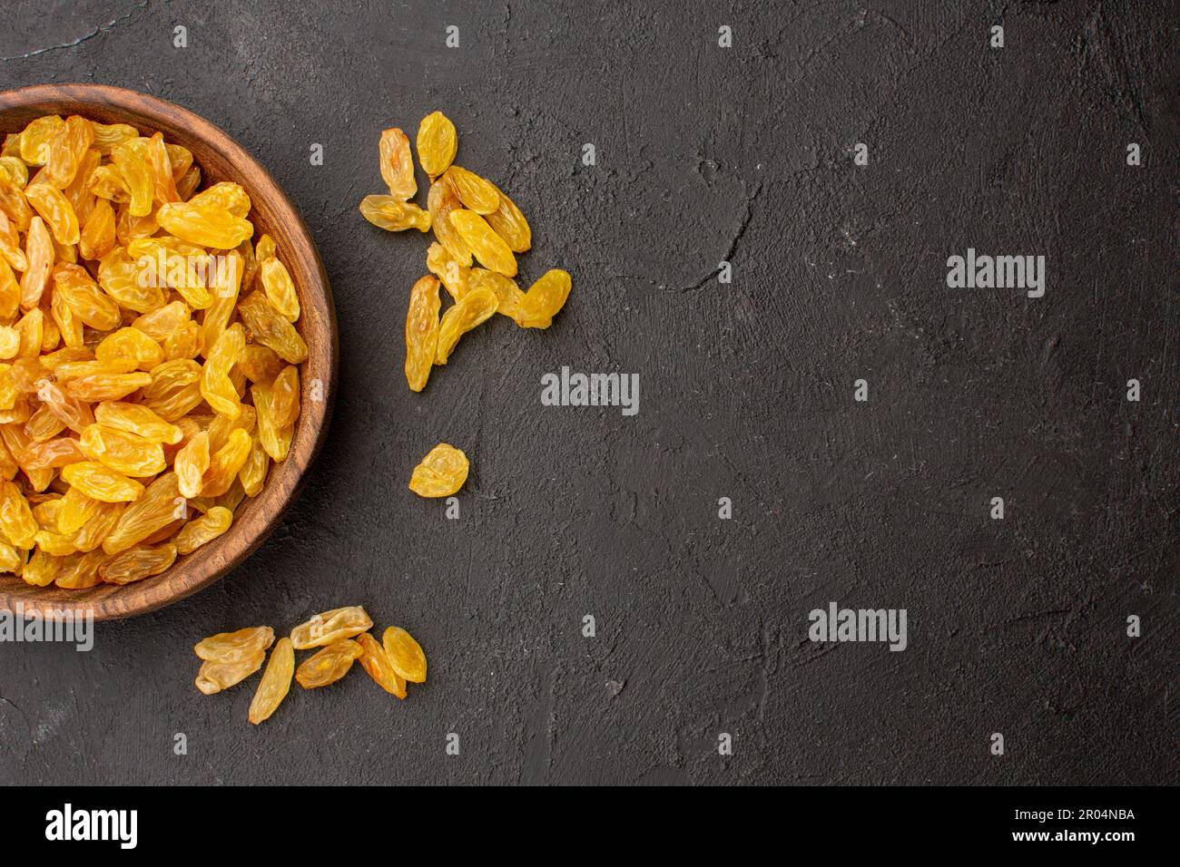 top view dried grape raisins inside plate on dark grey background dry ...
