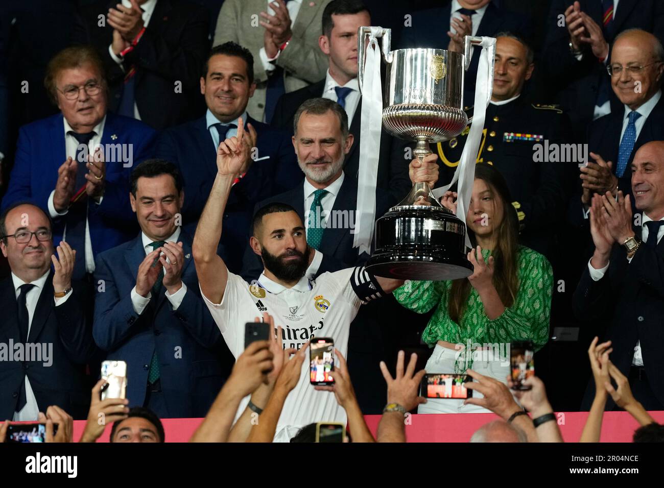 Real Madrid's captain Karim Benzema lefts the trophy in front of Spain ...