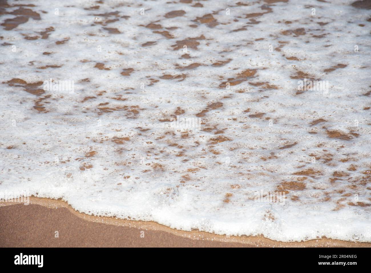 Top view of the foam of a wave arriving at the seashore Stock Photo - Alamy