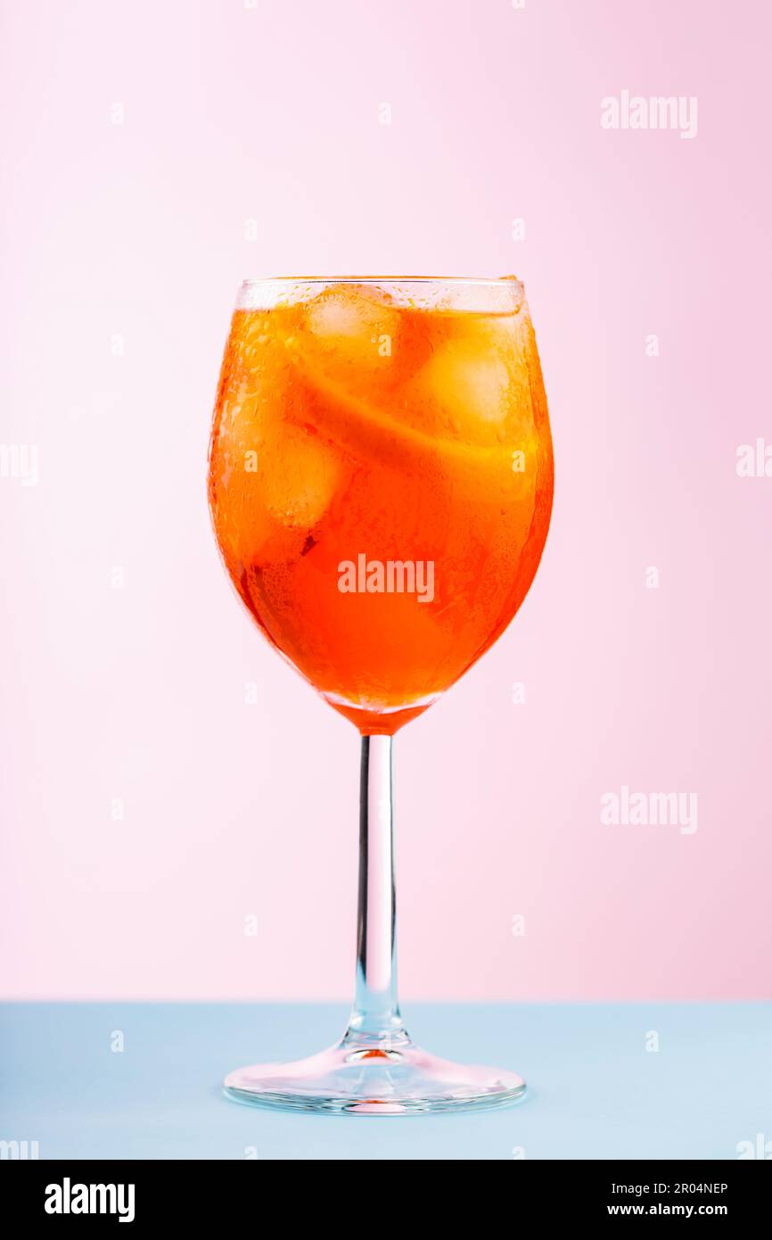 Aperol Spritz cocktail in glass on a pink blue background. Cocktail ...