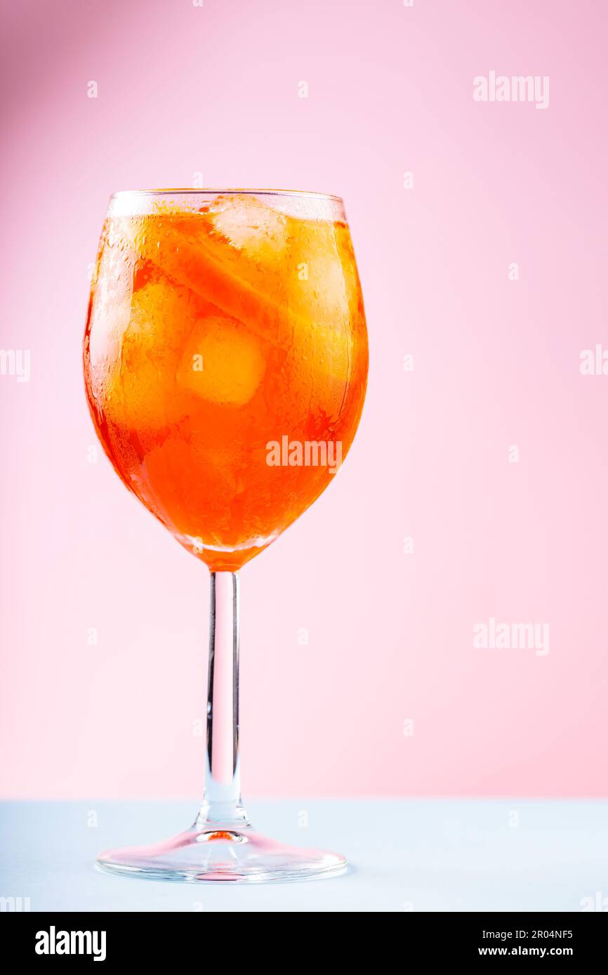 Aperol Spritz cocktail in glass on a pink blue background. Cocktail ...