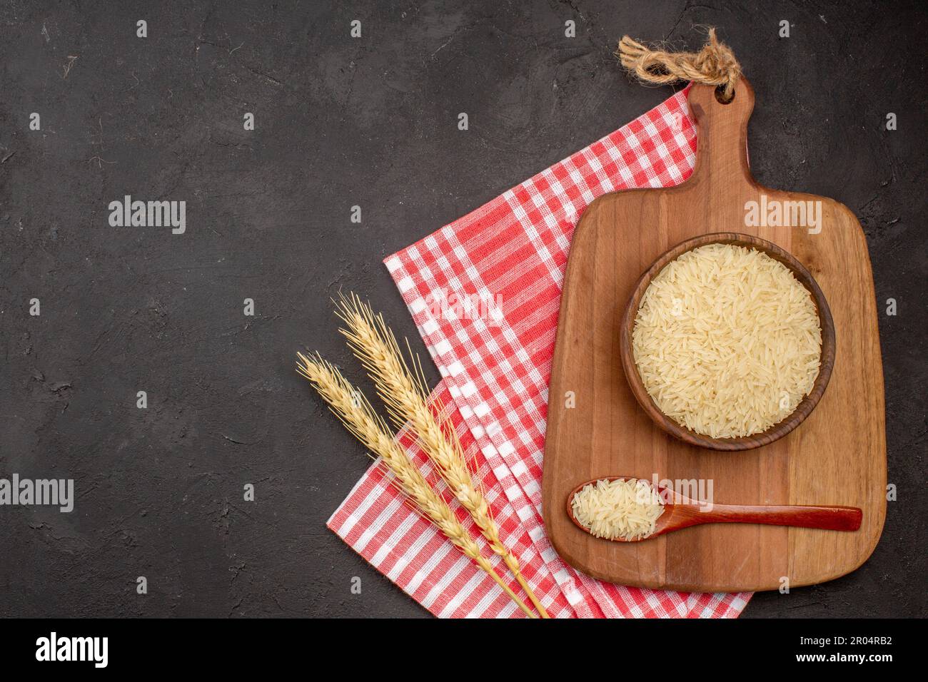 top view raw rice inside wooden plate on grey background raw rice east ...