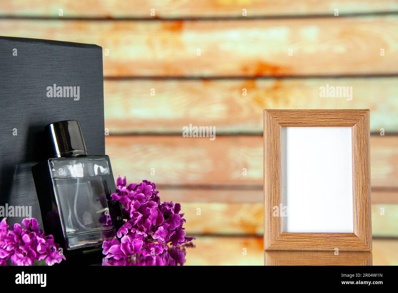 front view black expensive fragnance with picture frame on light ...