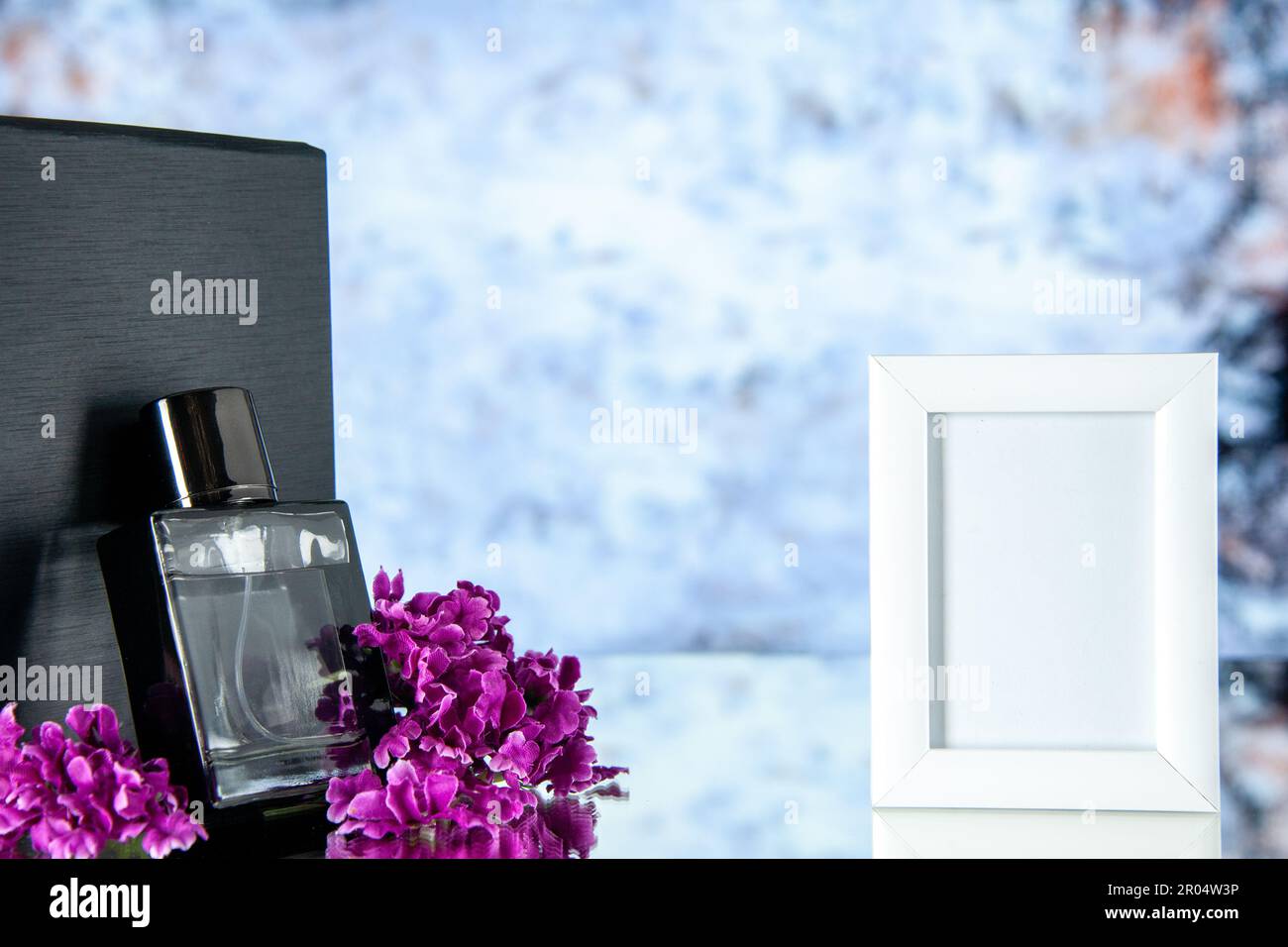 front view black expensive fragnance with picture frame on light ...