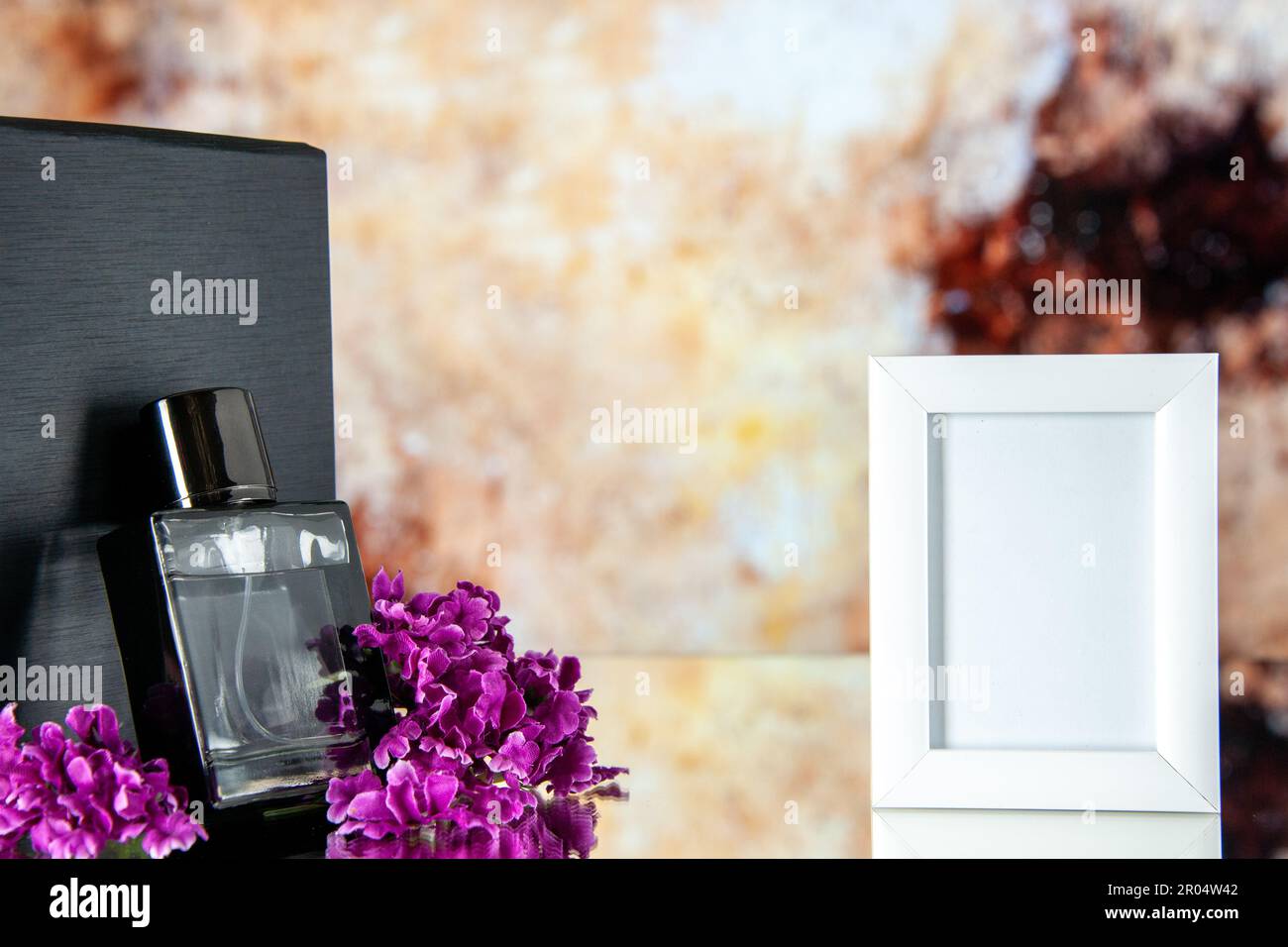 front view black expensive fragnance with picture frame on light ...