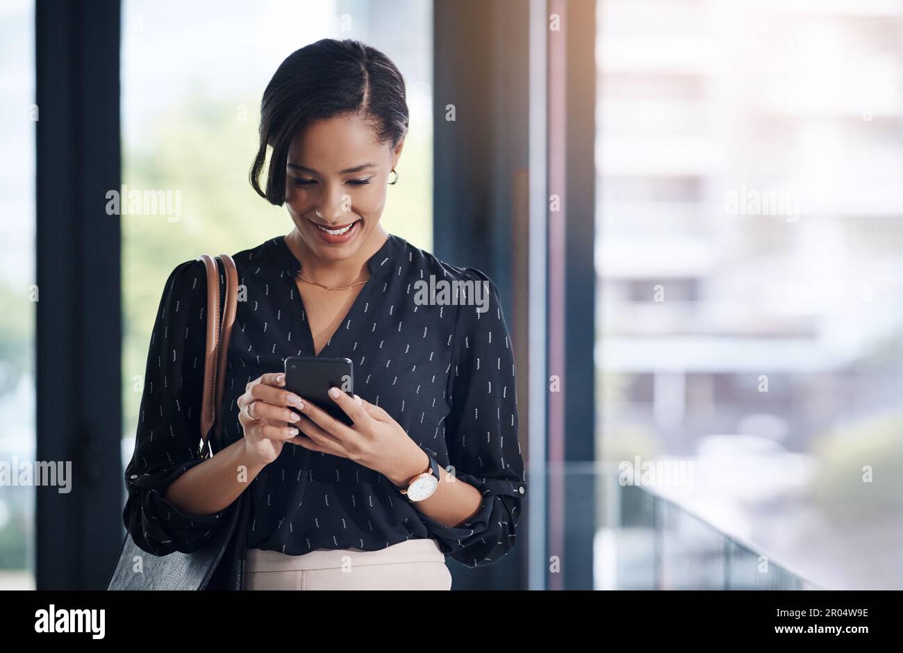 Stepping out for her next meeting. a young businesswoman using a ...