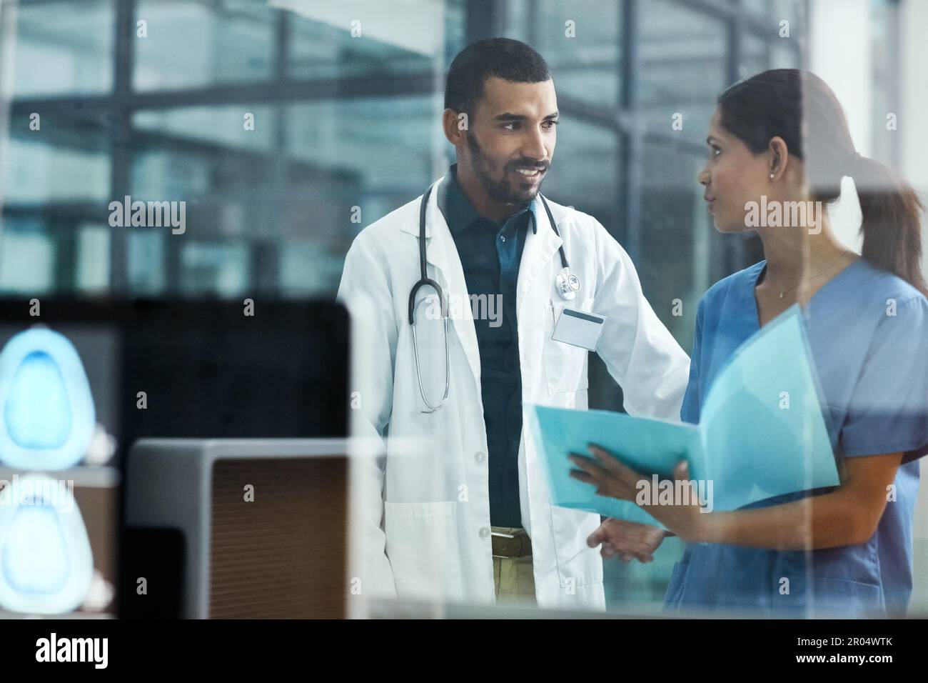 Taking a deeper look into the diagnosis. two young doctors discussing ...