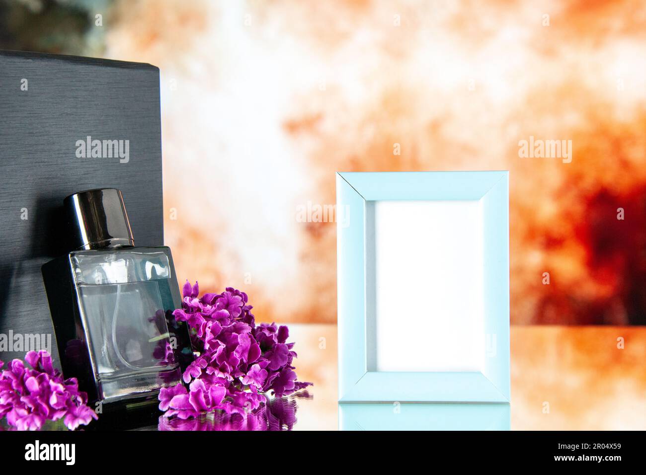 front view black fragnance with blue picture frame on light brown ...