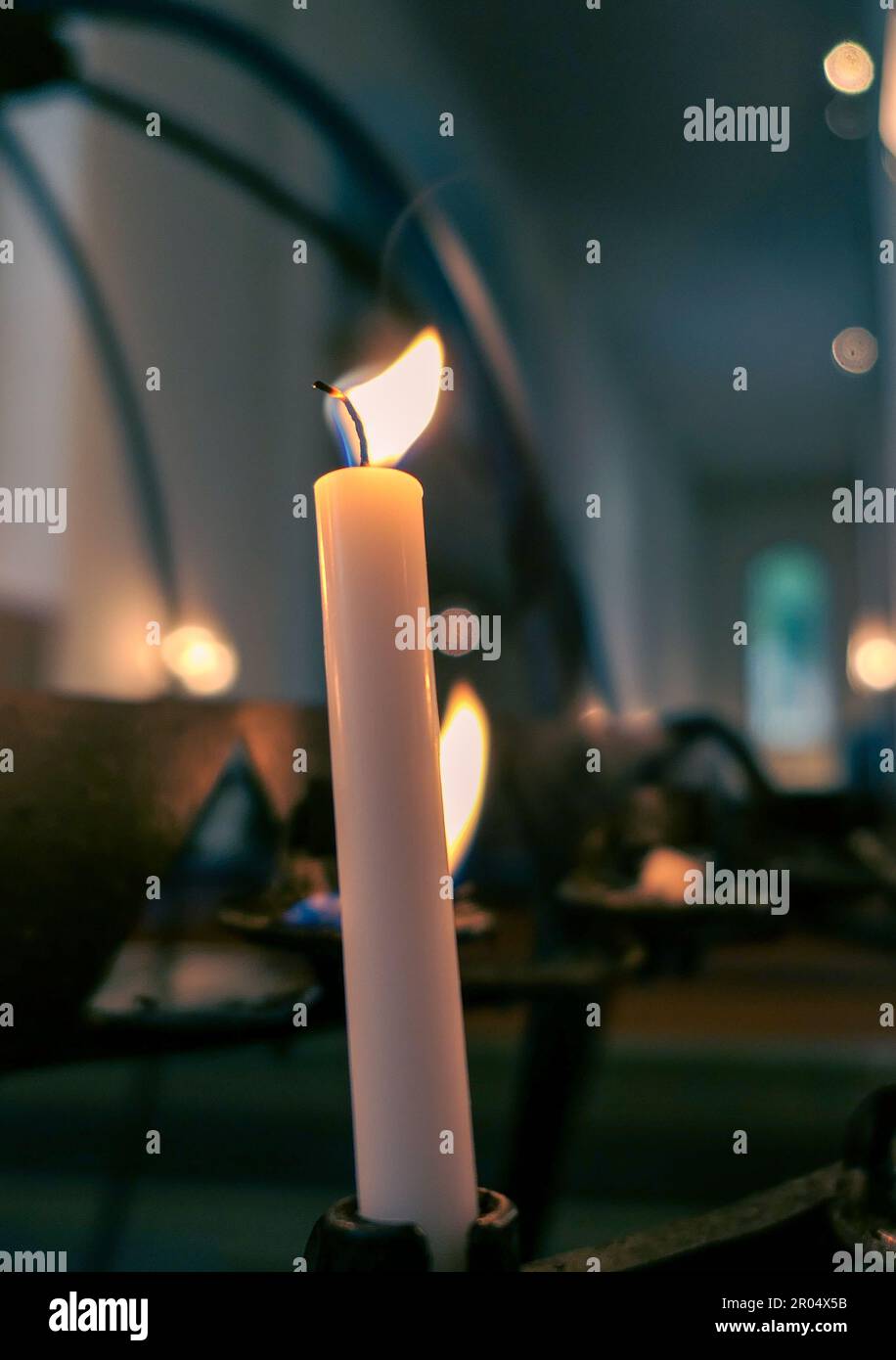 A close up of a candle inside a church Stock Photo - Alamy