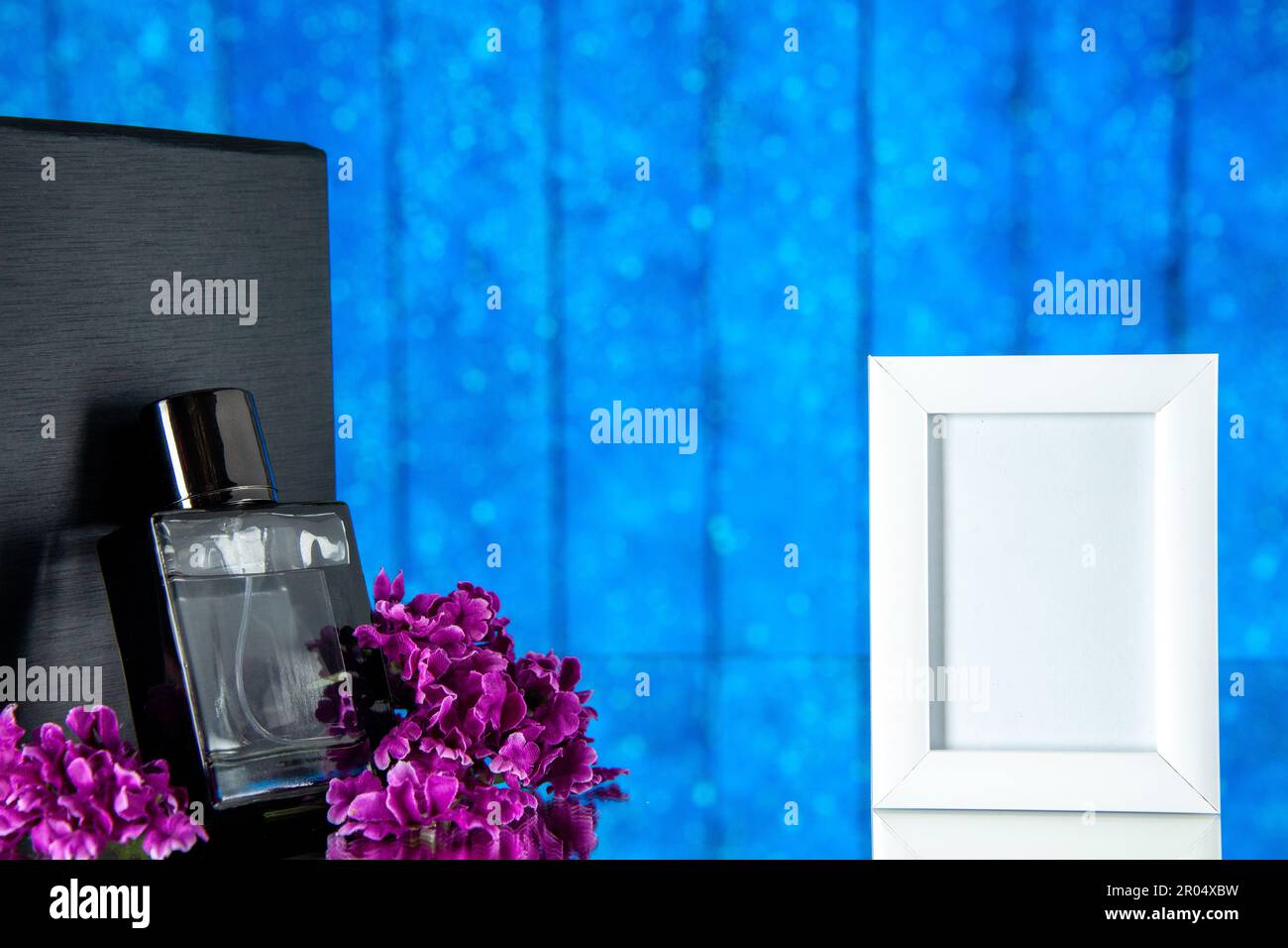 front view black fragnance with picture frame on the blue background ...