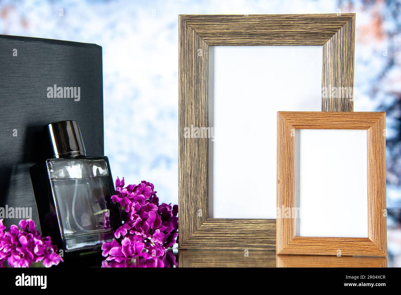 front view black fragnance with picture frames on light background ...