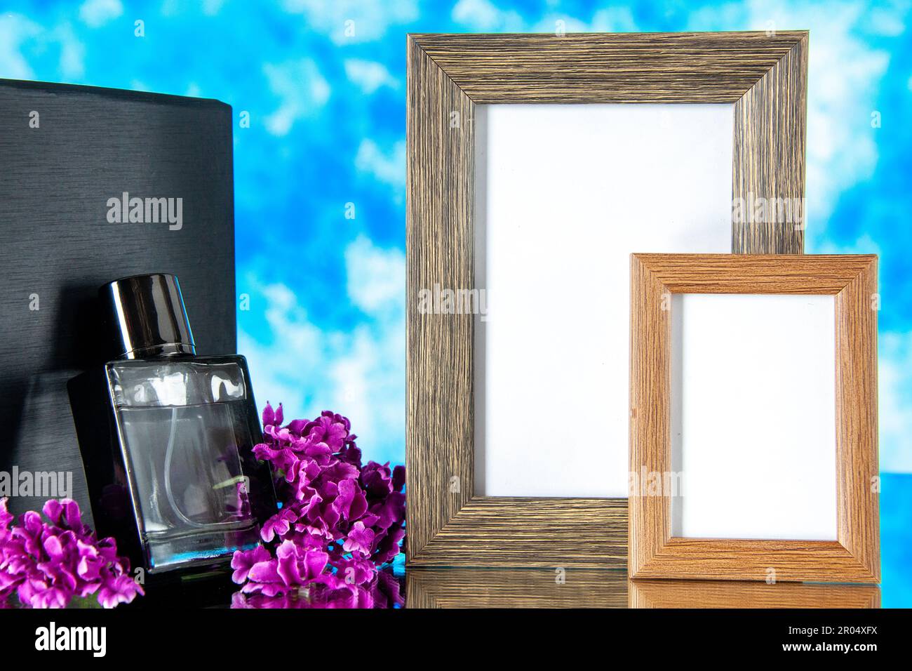 front view black fragnance with picture frames on the light-blue ...