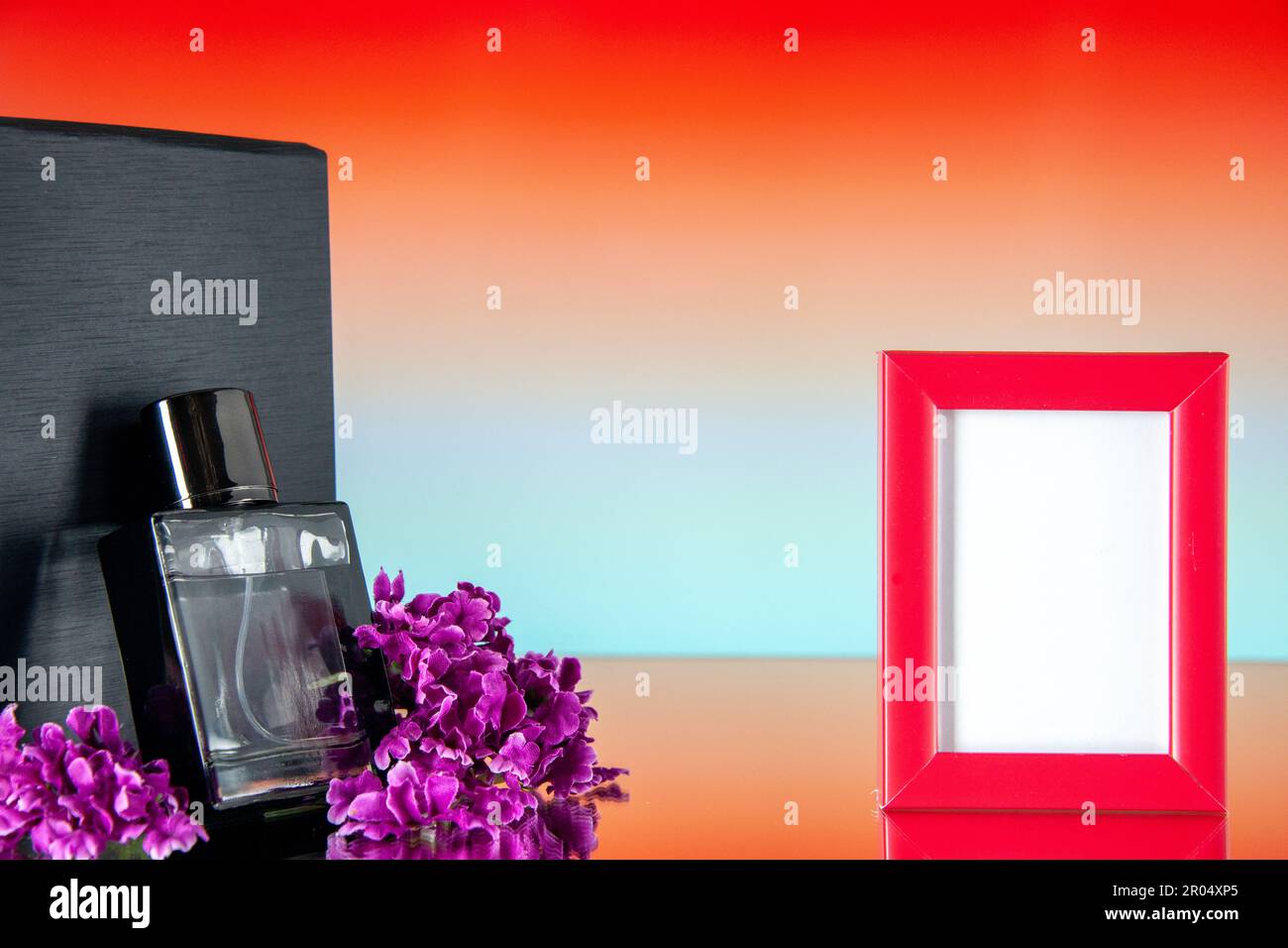 front view black fragnance with pink picture frame on light red ...