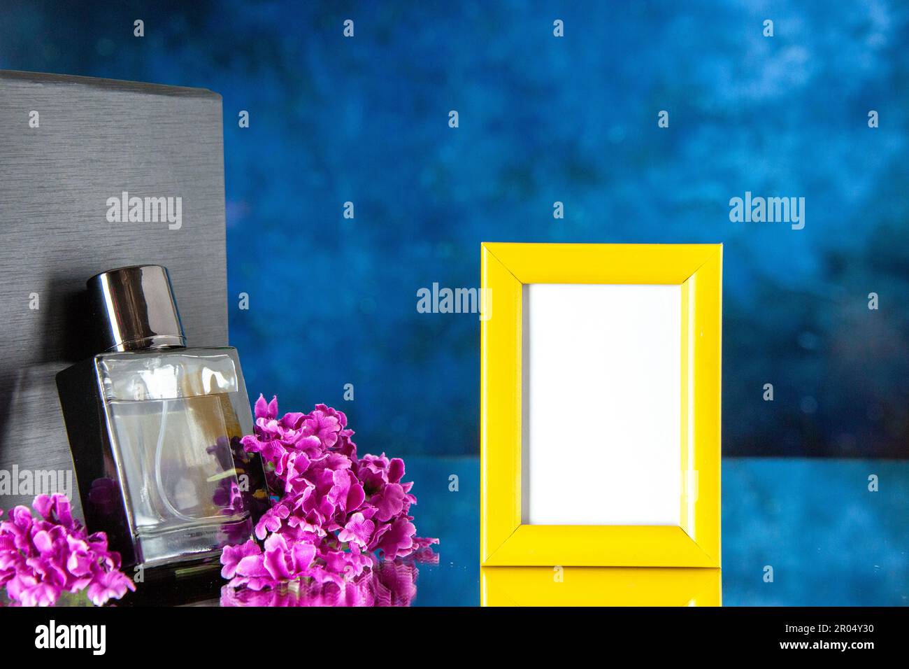 front view black fragnance with yellow picture frame on the blue ...