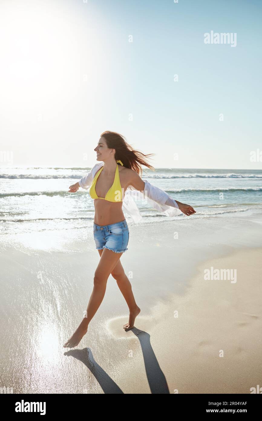 I love summer because I get to enjoy a beach day. a beautiful young woman enjoying her day at ...