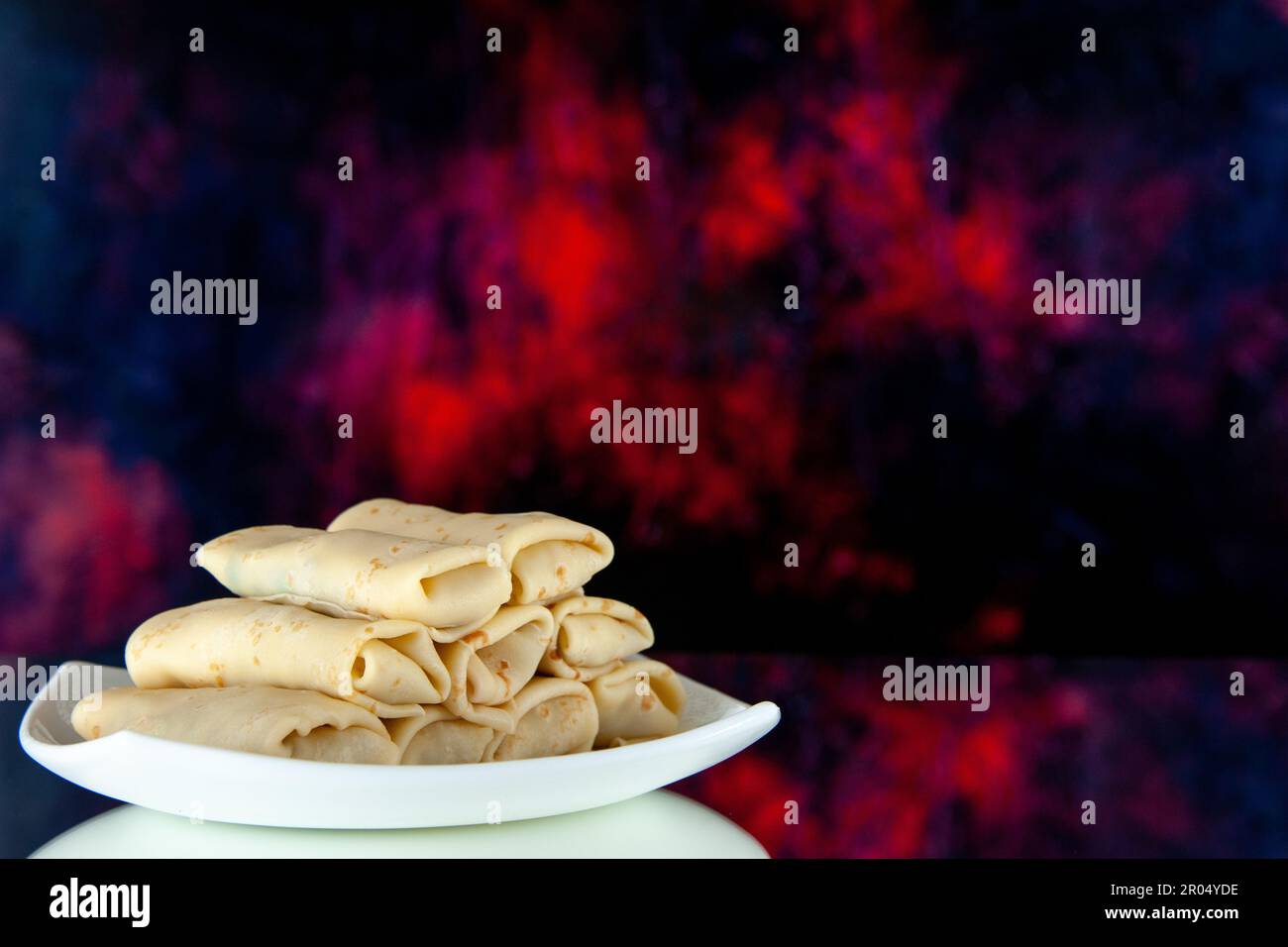 front view delicious sweet pancakes rolled inside plate on dark ...