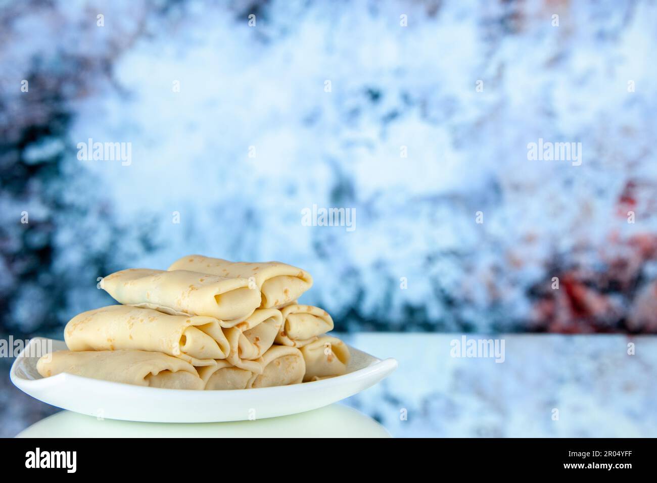 front view delicious sweet pancakes rolled inside plate on light ...
