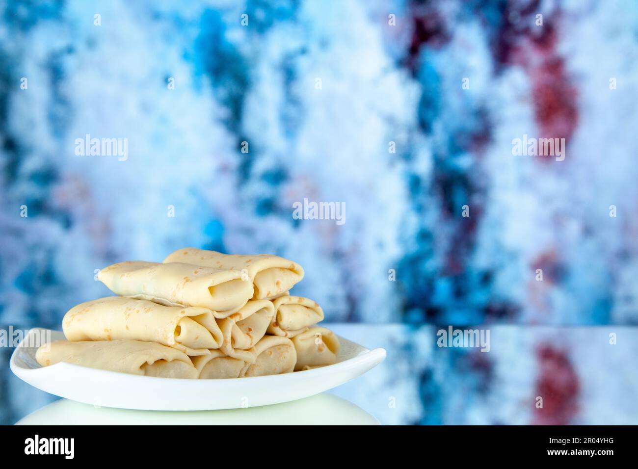 front view delicious sweet pancakes rolled inside plate on the light ...