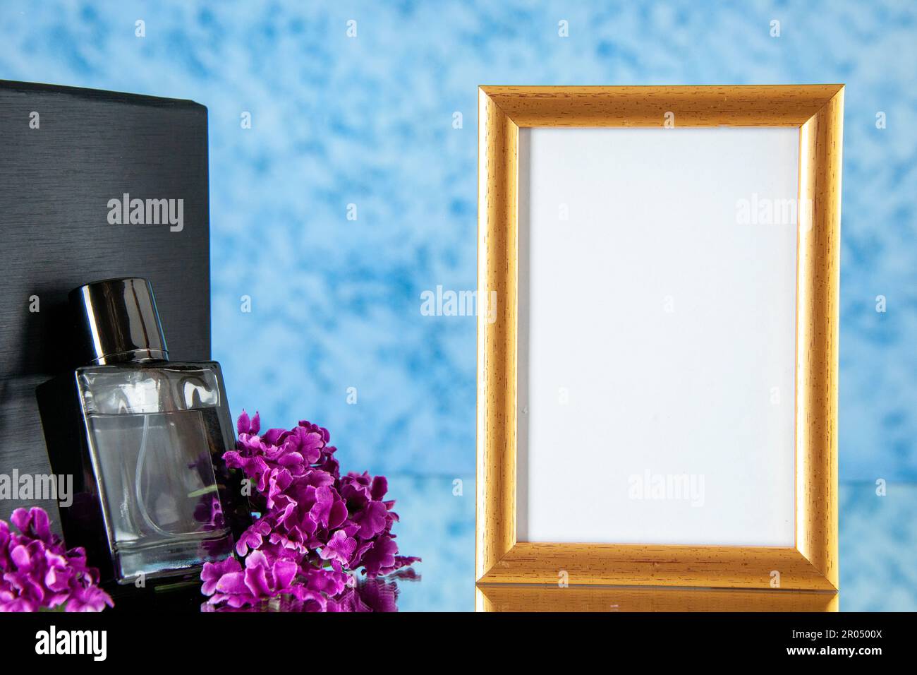 front view expensive fragnance with picture frame on light background ...