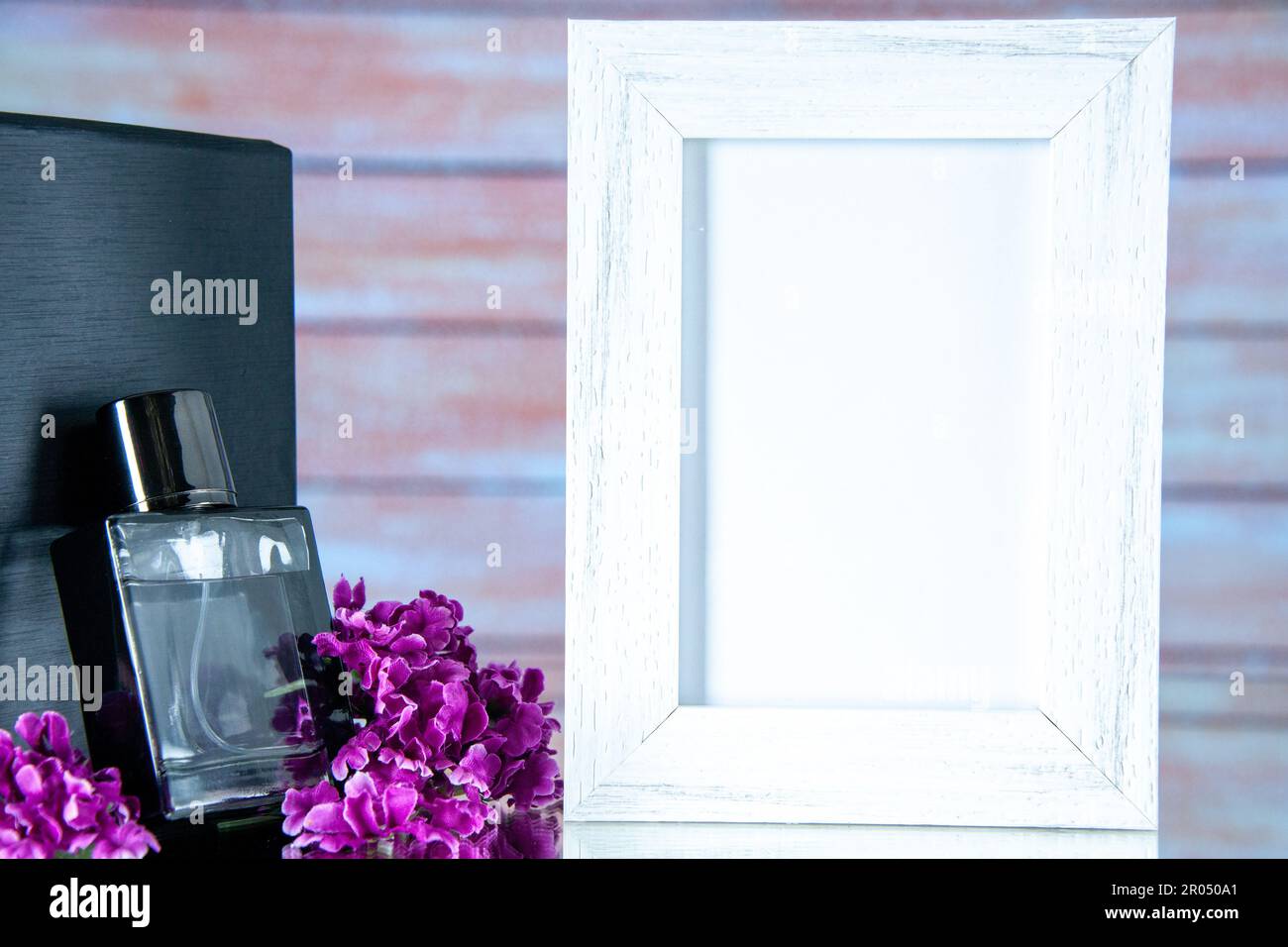 front view expensive fragnance with picture frame on the light ...