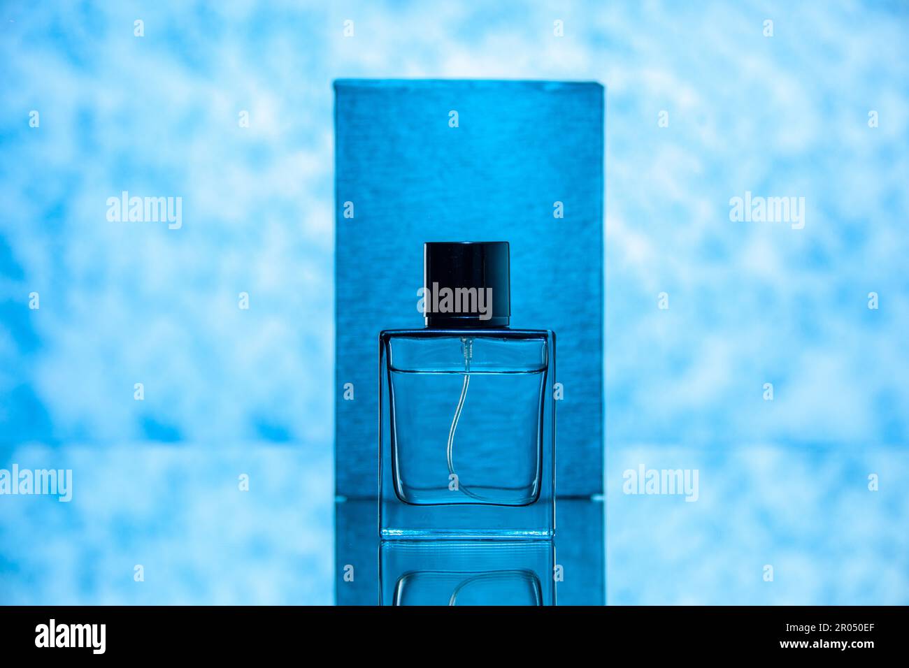 front view expensive perfume in flask on light blue background ...