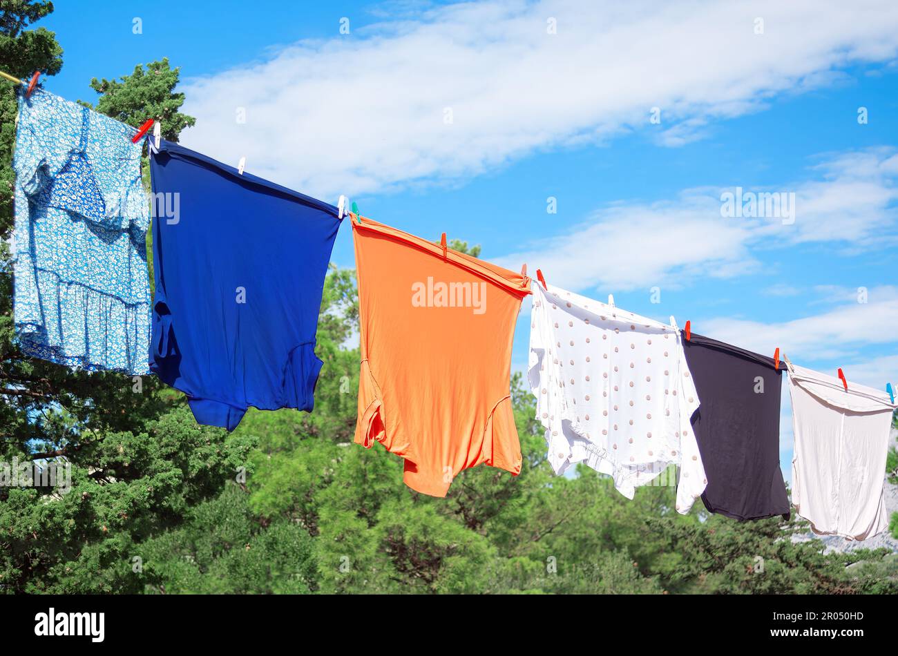 Washed clothes on rope . Outdoor laundry drying Stock Photo - Alamy