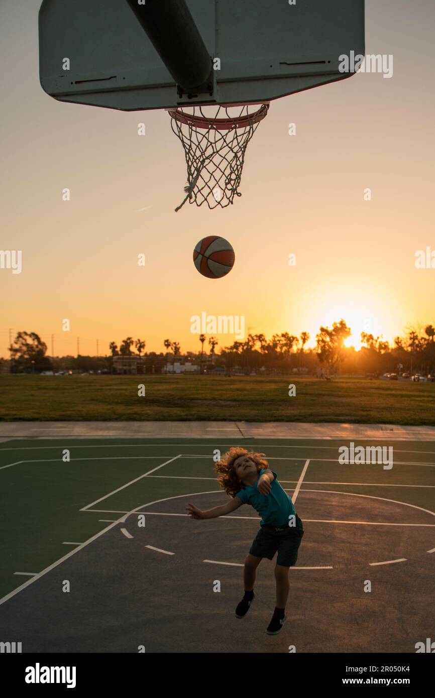 Happy little boy kid playing basketball on playground. Cute little boy ...